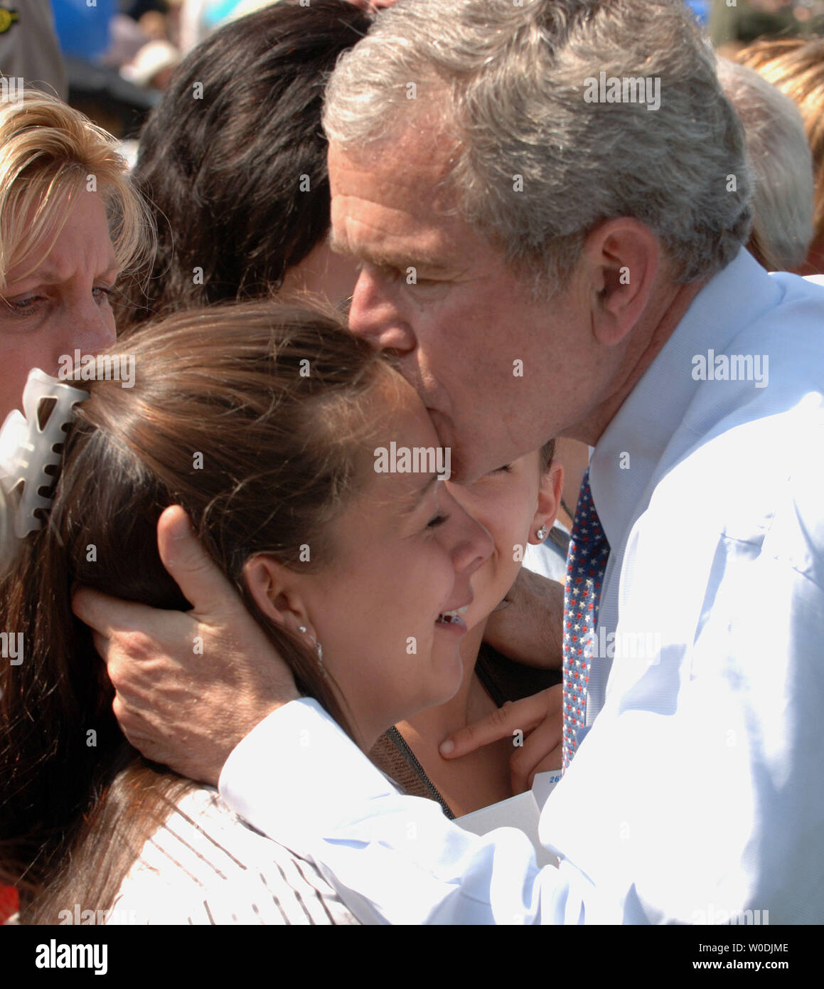 U.S. President George W. Bush comforts a crying guest at the Annual ...