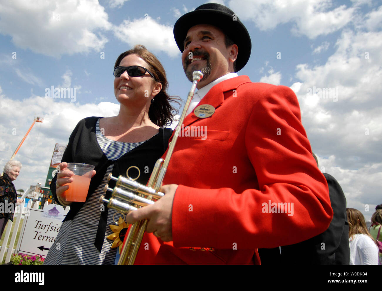 Karin Glasgow poses for a photo with the Preakness bugler, at the ...