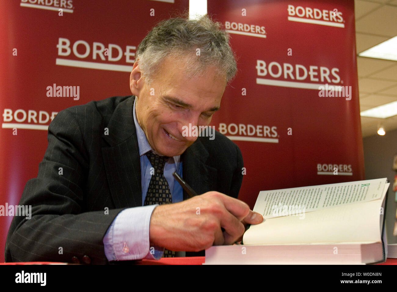 Consumer activist and former presidential candidate Ralph Nader signs ...