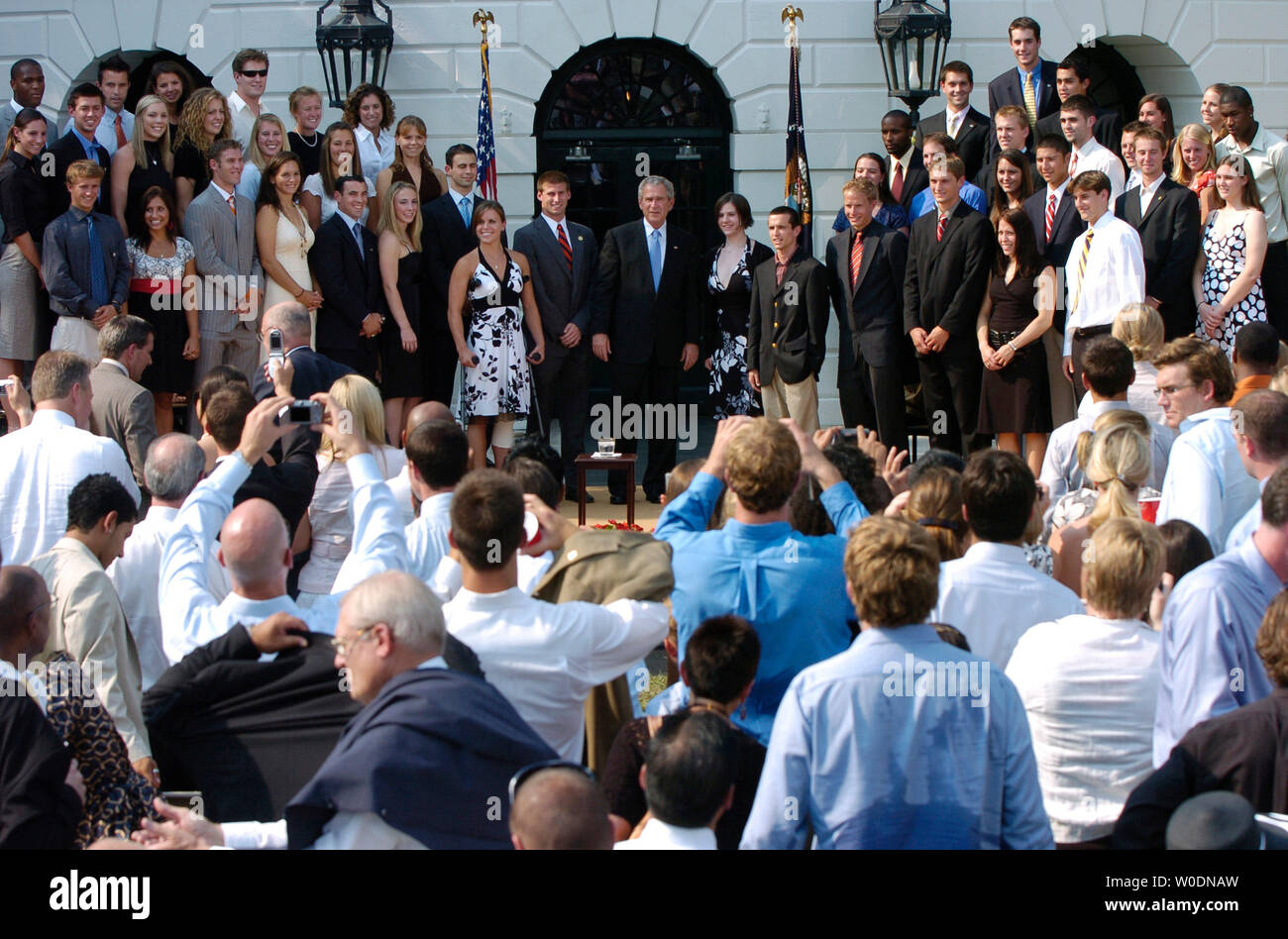 U.S. President George W. Bush, flanked by team captains of the NCAA ...