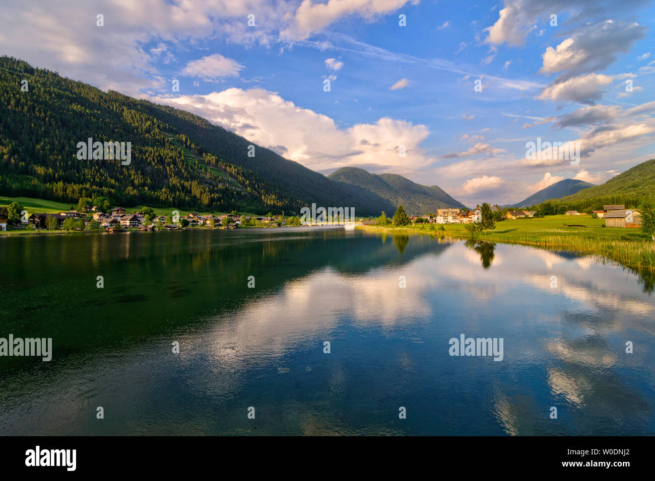 Beautiful Alpine lake with clouds reflection in the water Stock Photo ...
