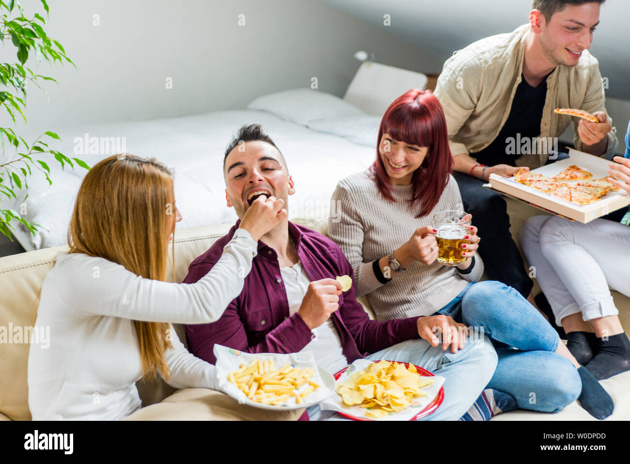 Group of happy friends bonding at home - Young adults having party and ...