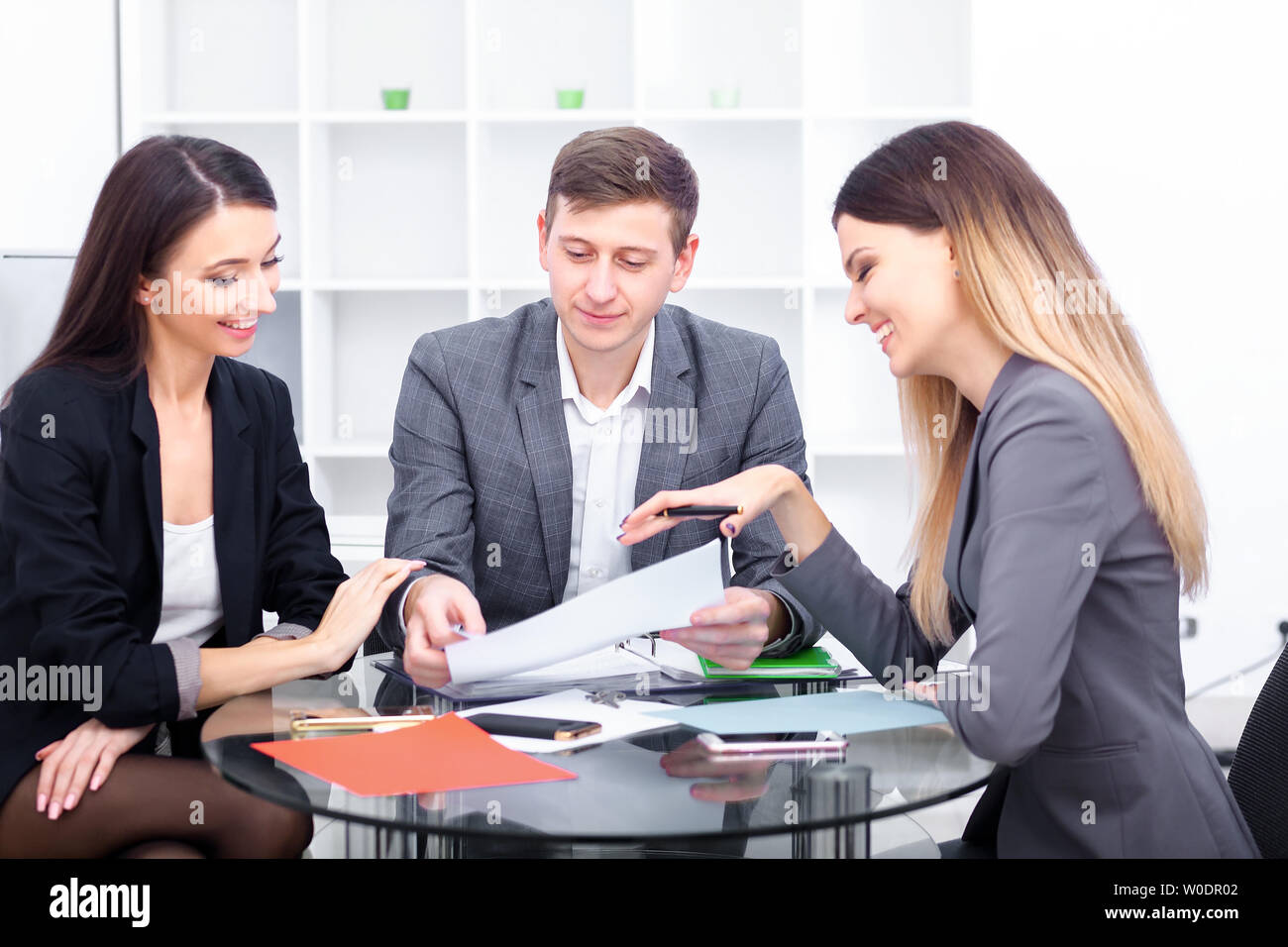 Sales manager giving advice to his couple clients Stock Photo - Alamy