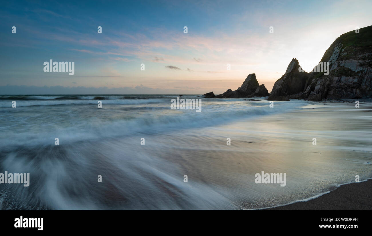 Beautiful sunset landscape image of Westcombe Beach in Devon England ...