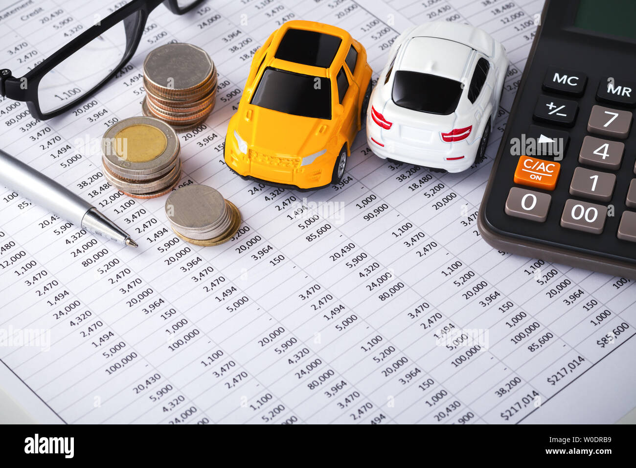 Cars with coins and calculator on financial statement background with ...