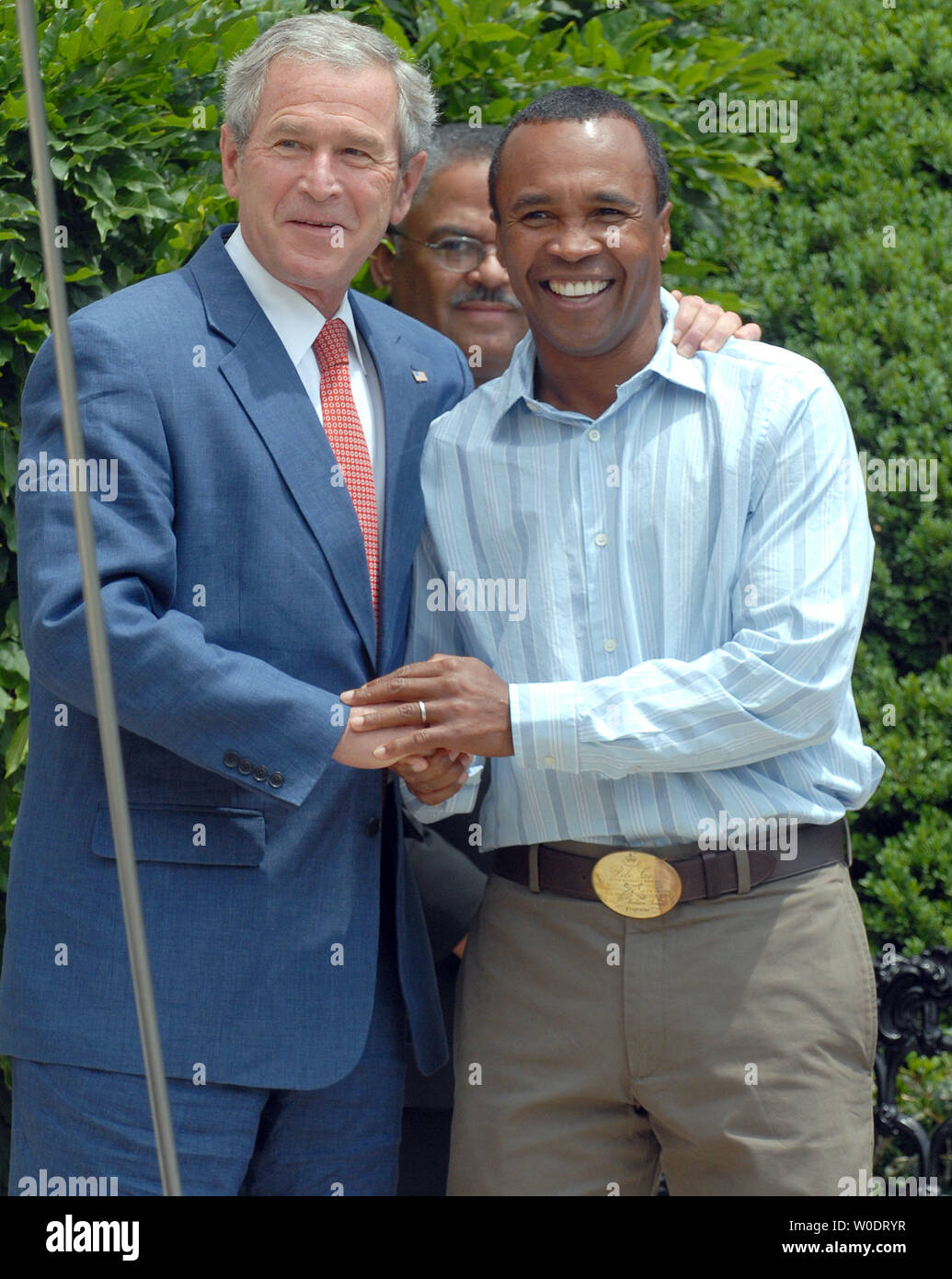 U.S. President George W. Bush shakes hands with boxer Sugar Ray Leonard ...