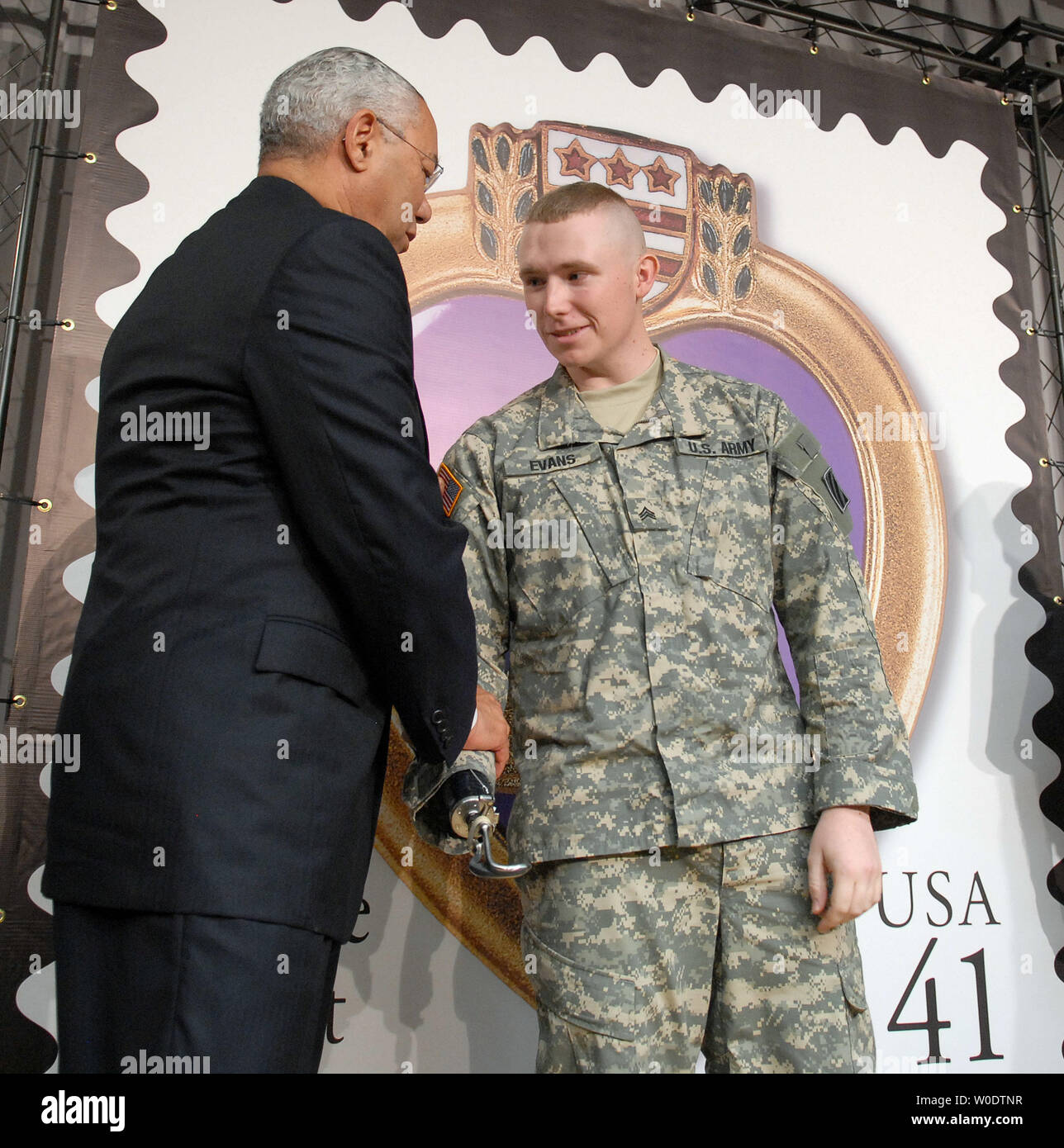 Former Secretary of State Colin Powell (L) greets SGT Robert Evans, who ...