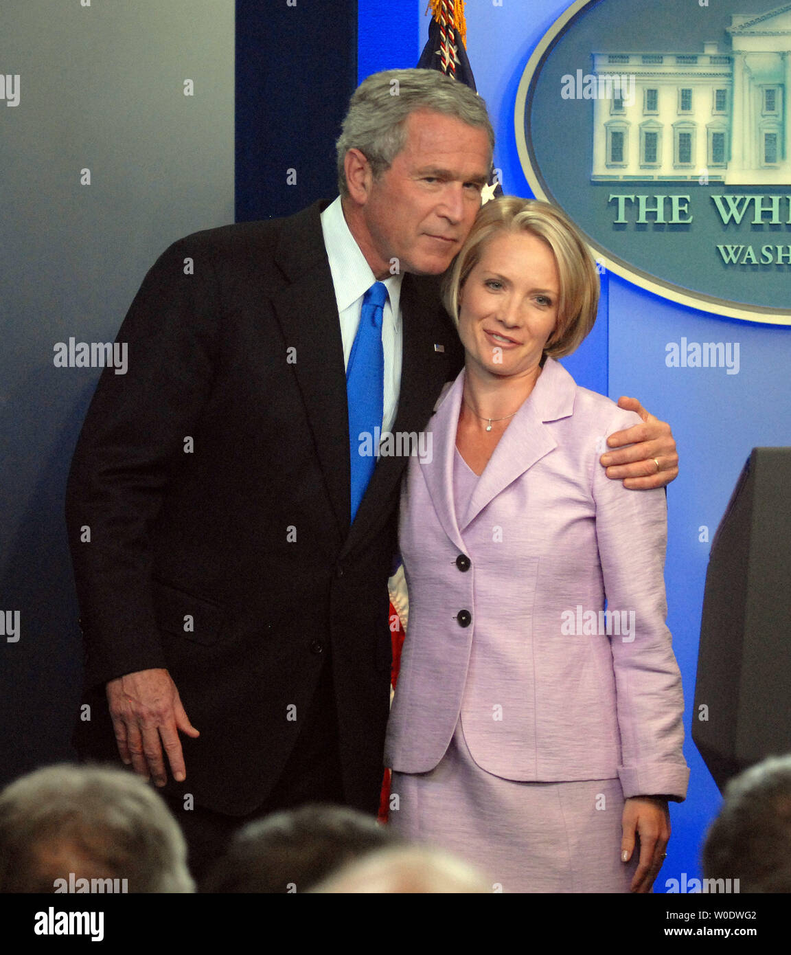 U.S. President George W. Bush hugs Dana Perino after bush announced ...