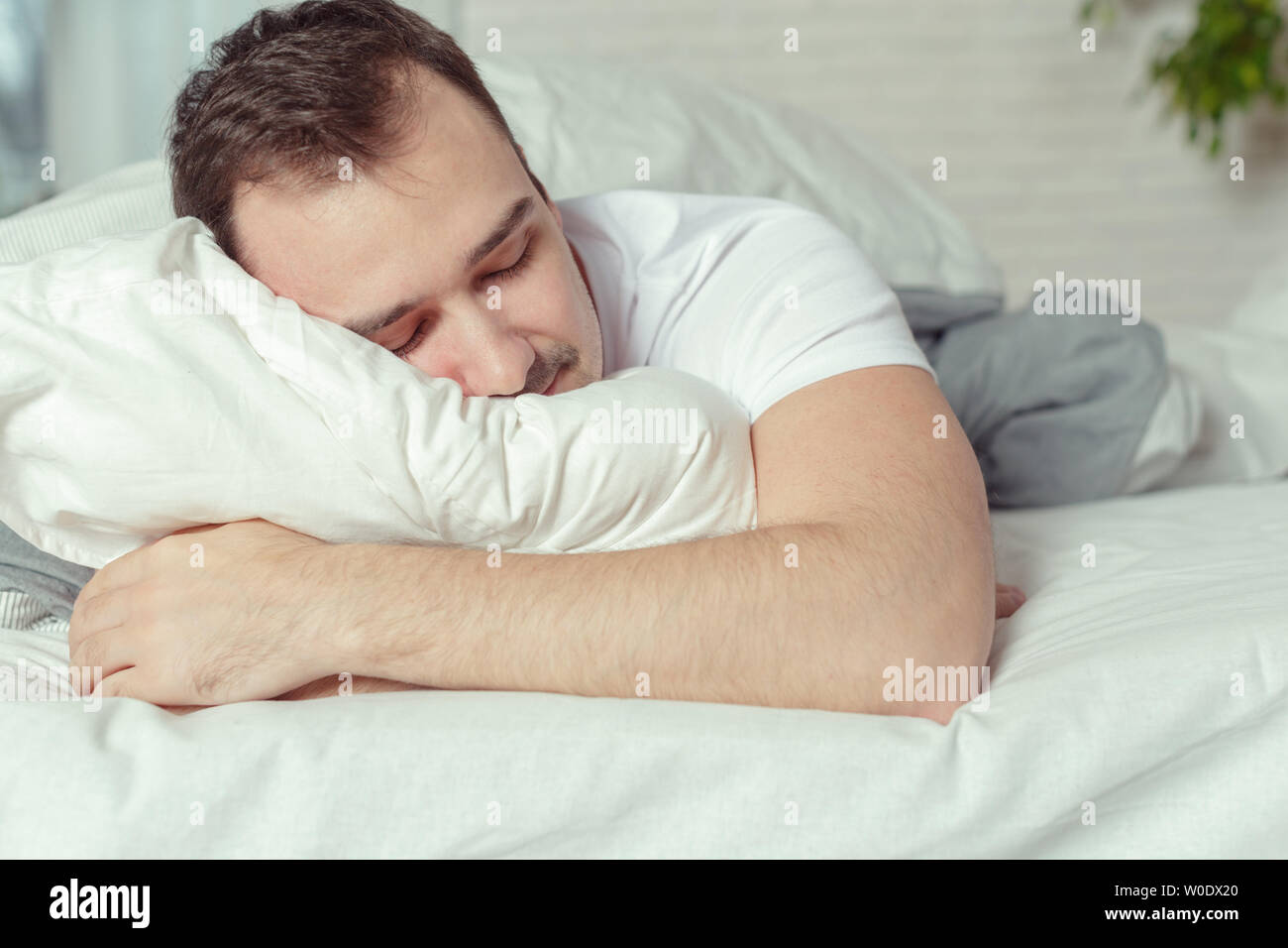 Young Man Sleeping On Bed In Bedroom Stock Photo - Alamy