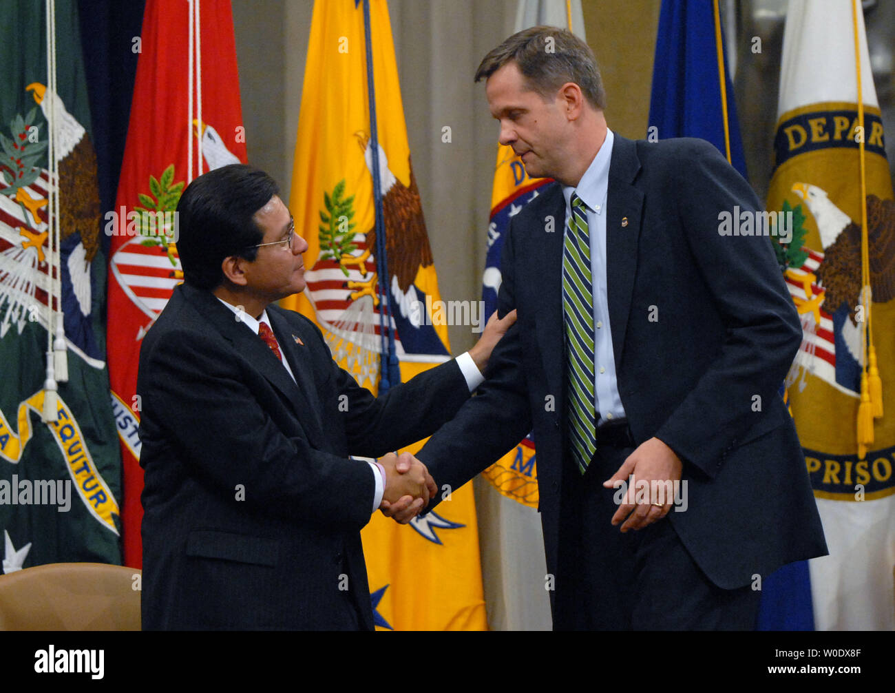 U.S. Attorney General Alberto Gonzales (L) shakes hands with Acting ...