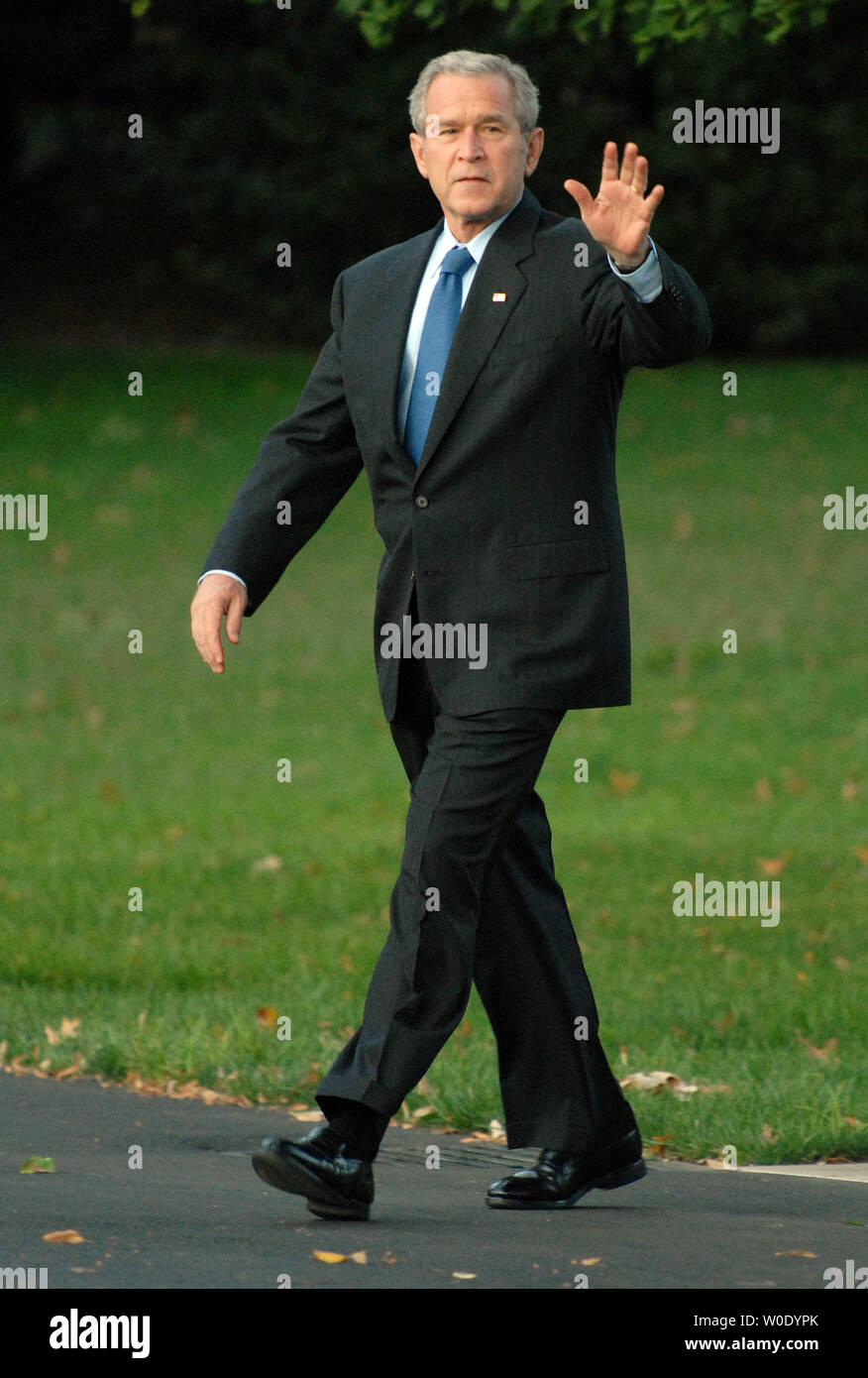 U.S. President George W. Bush waves as he departs from the South Lawn ...