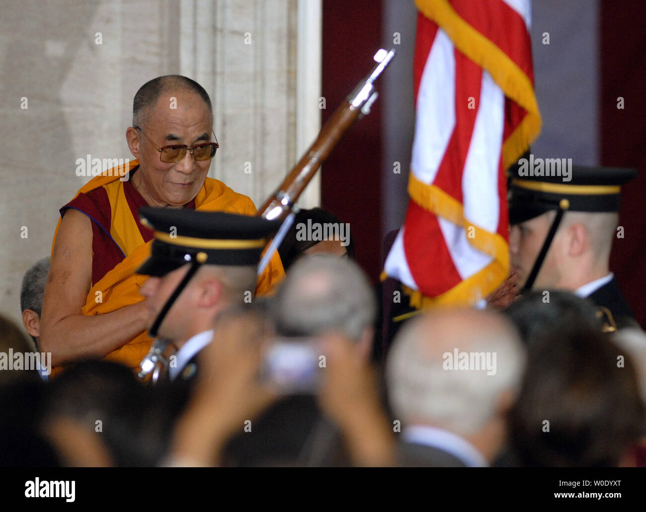 The Dalai Lama watches as the American Flag is posted during a ...