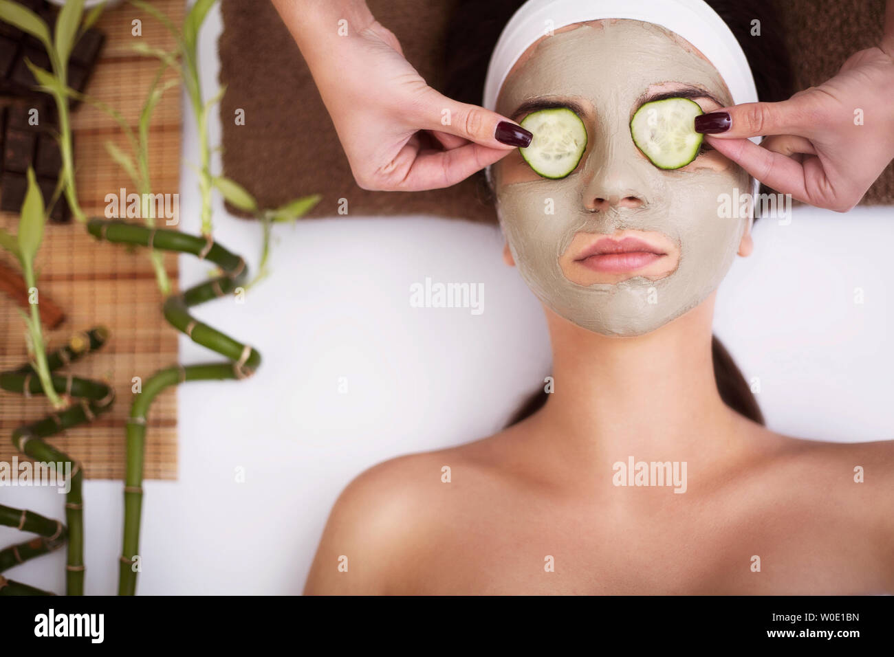 Spa Beautiful Young Woman Is Getting Facial Clay Mask At Spa Lying