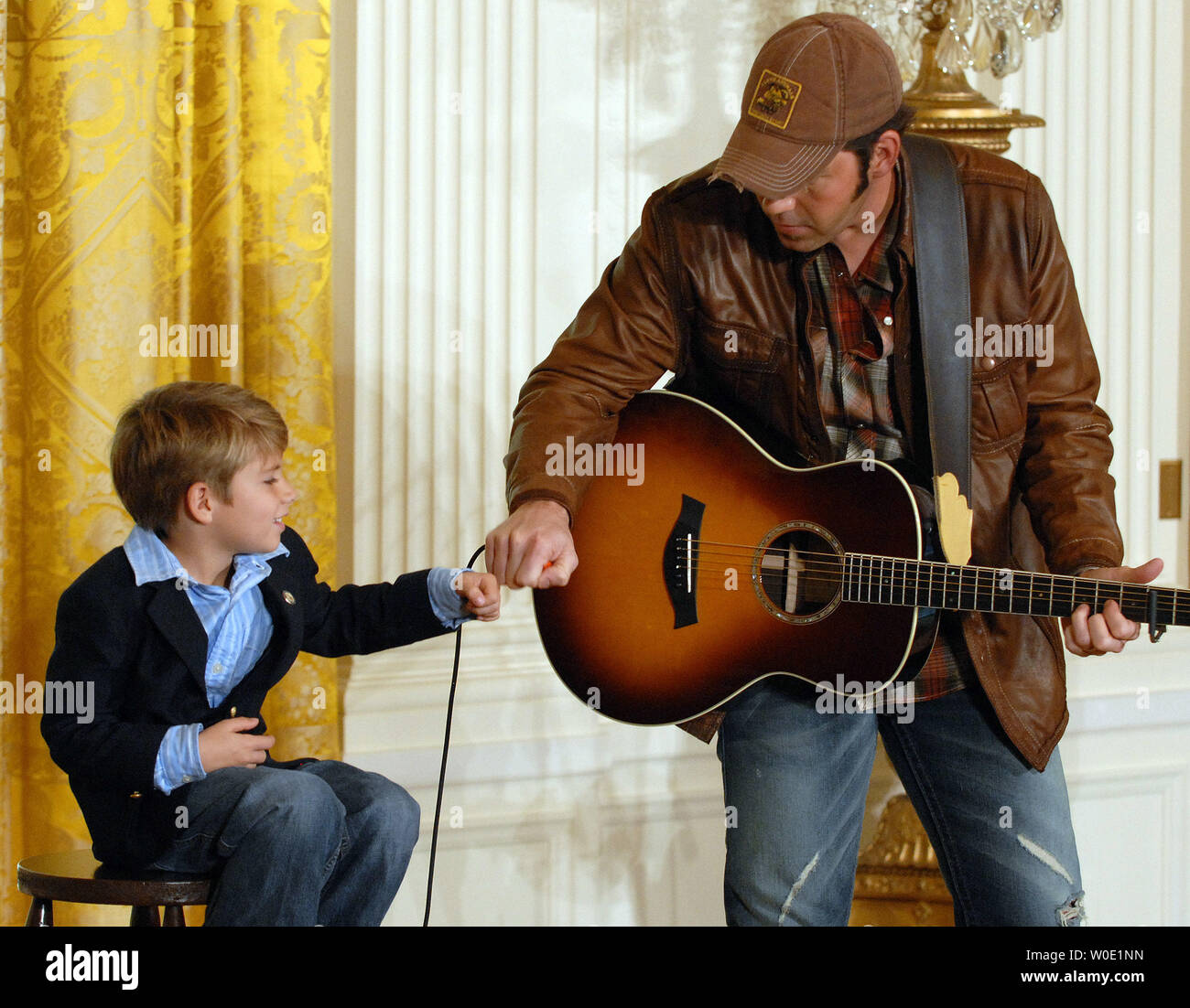 Country singer Rodney Atkins taps fists with his son Elijah, 6, after ...