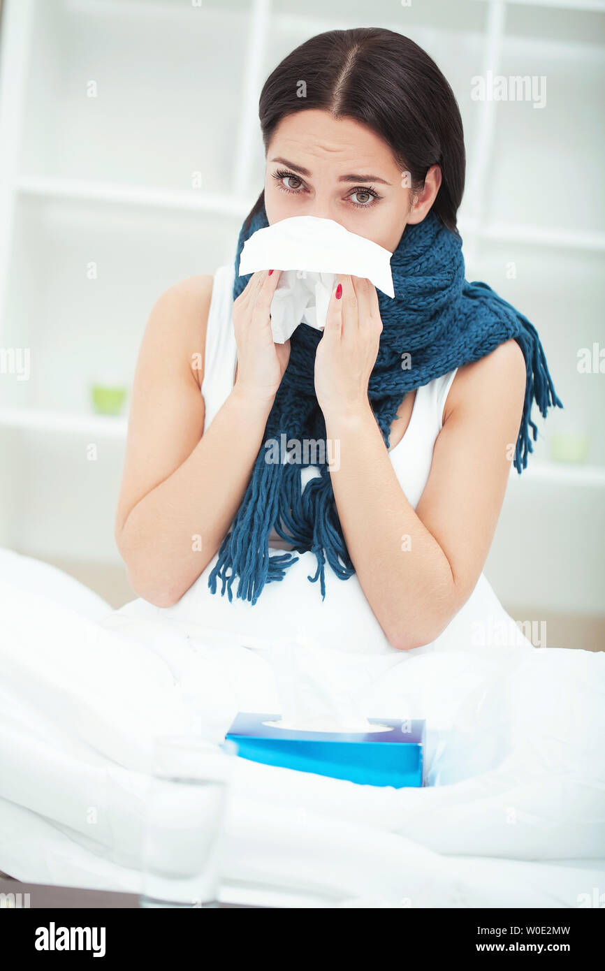 Woman Suffering From Cold Lying In Bed With Tissue Stock Photo - Alamy