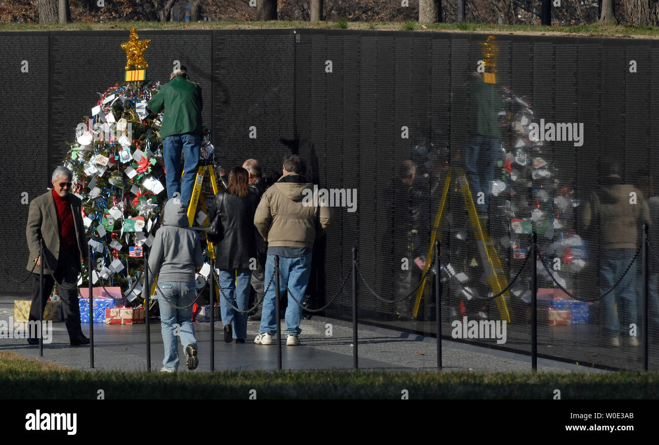 Volunteers decorate a Christmas tree at the Vietnam Veterans Memorial ...