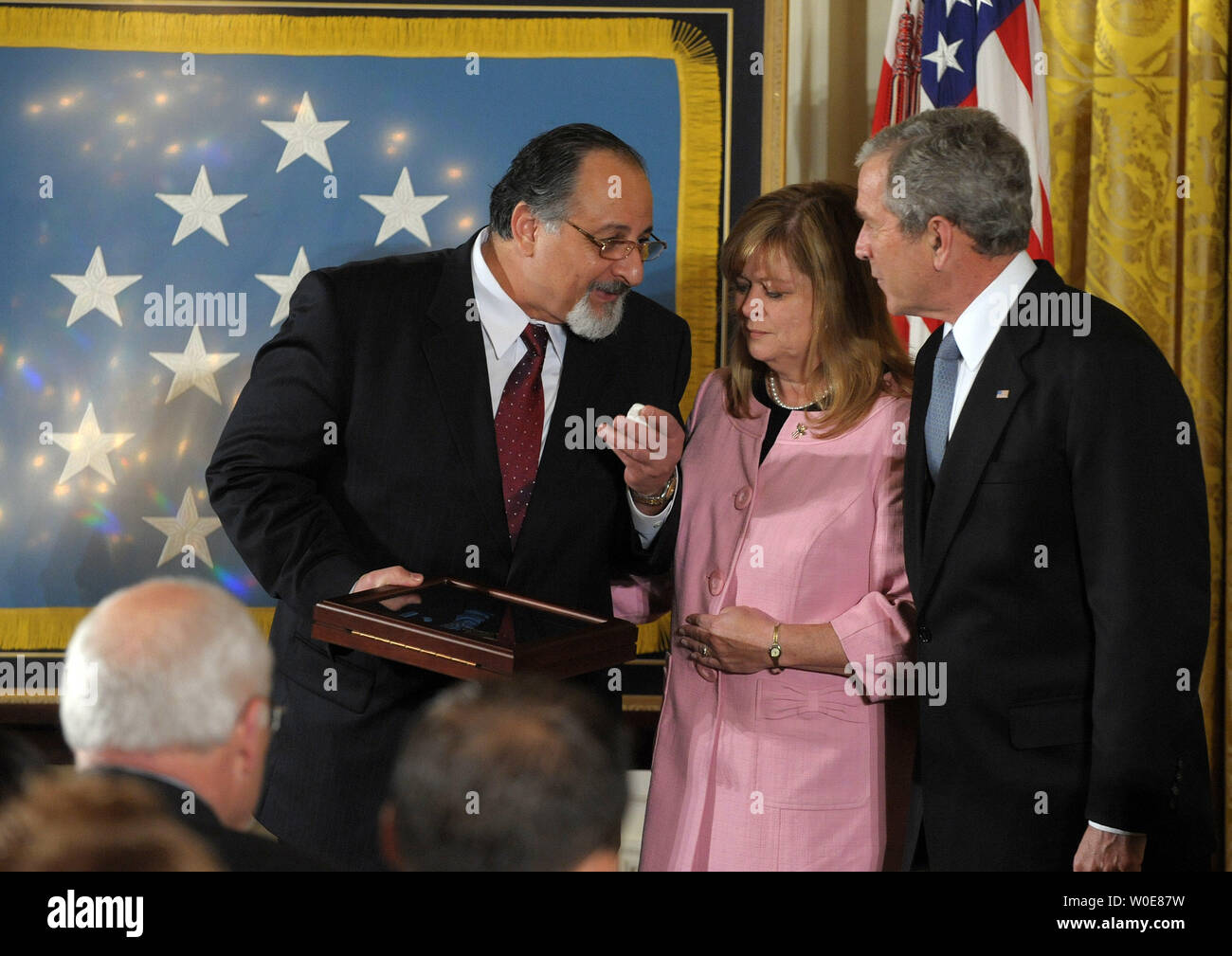 U.S. President George W. Bush stands with George and Sally Monsoor, the ...
