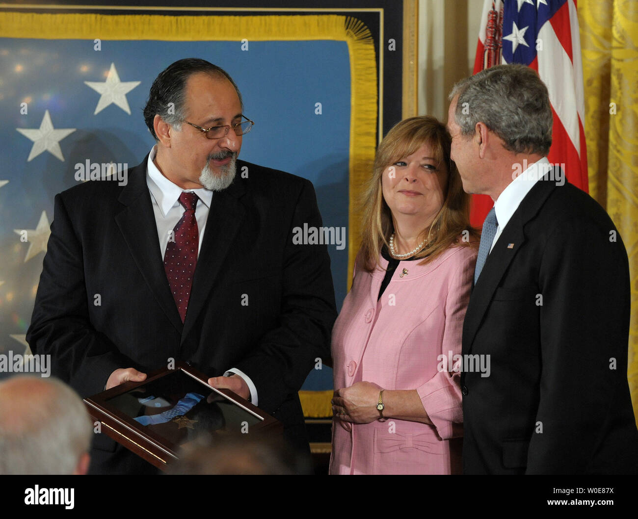U.S. President George W. Bush stands with George and Sally Monsoor, the ...