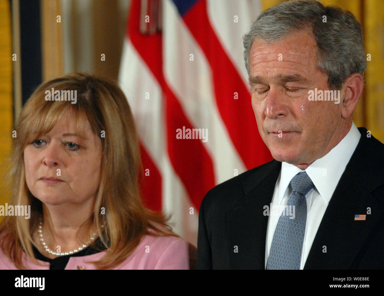 U.S. President George W. Bush cries as he stands with Sally Monsoor ...