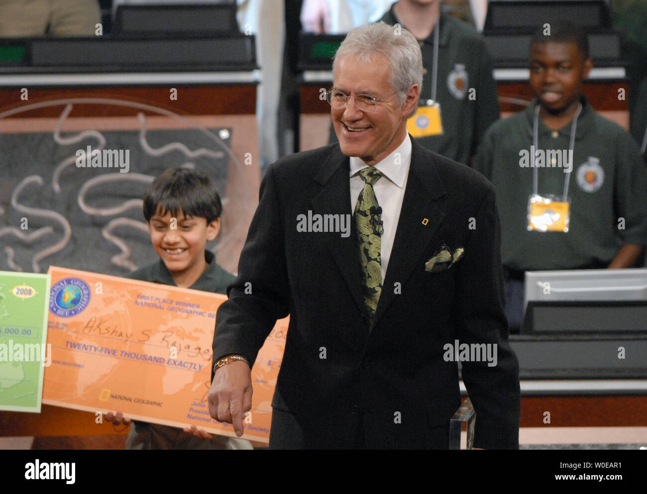 Geographic Bee winner Akshay Rajagopal (L) holds his prize, a $25,000 ...