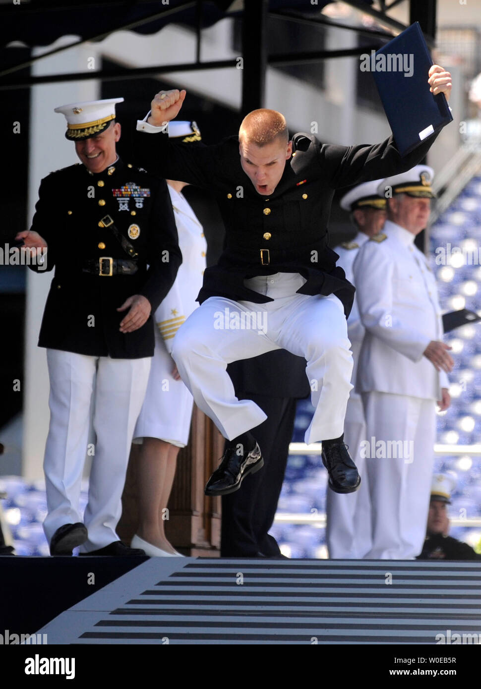 A midshipman celebrates after receiving his diploma during the Class of ...
