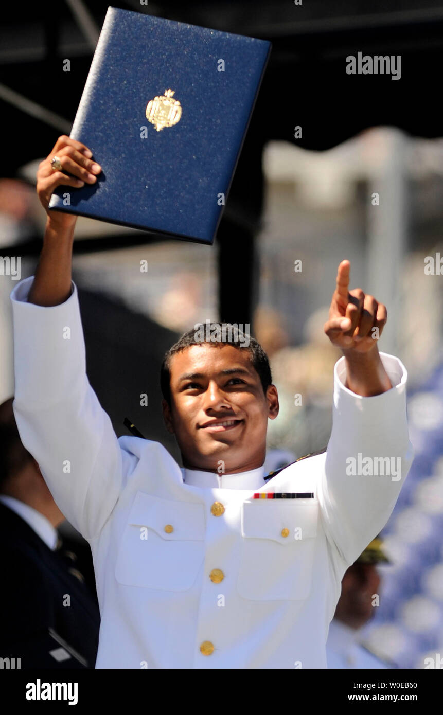 A Midshipman celebrates after receiving his diploma during the Class of ...