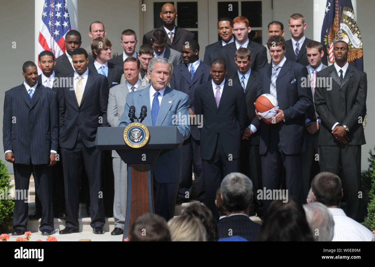 President George W. Bush delivers remarks alongside members of the ...