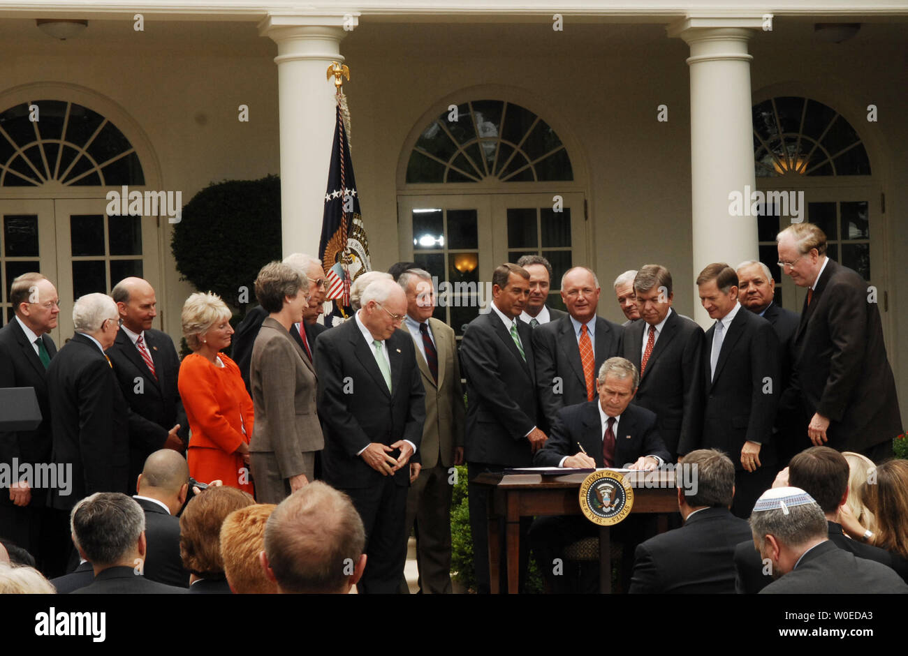 U.S. President George W. Bush, surrounded by members of Congress and ...