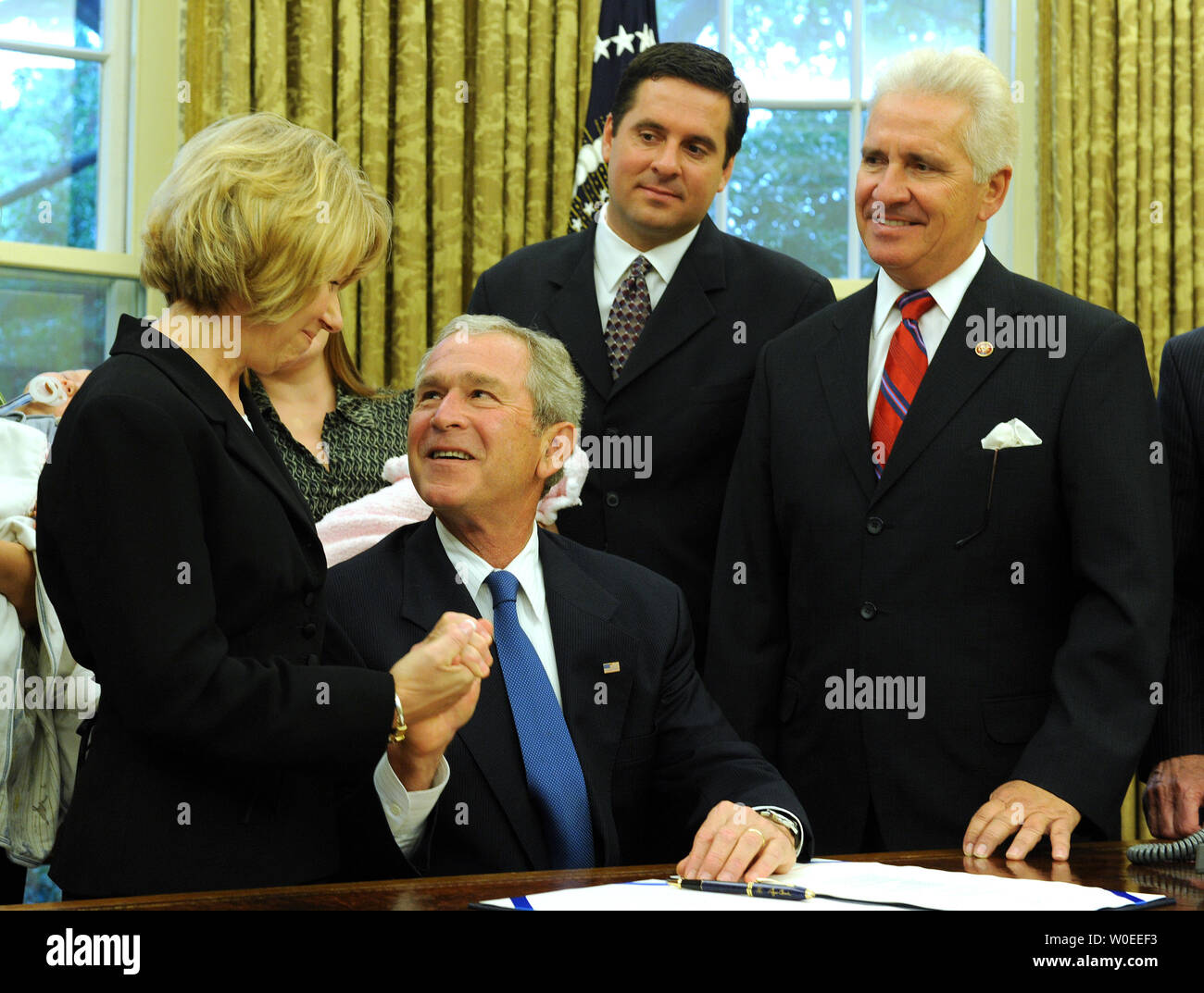 U.S. President George W. Bush holds hands with mother Peggy Hubbard ...