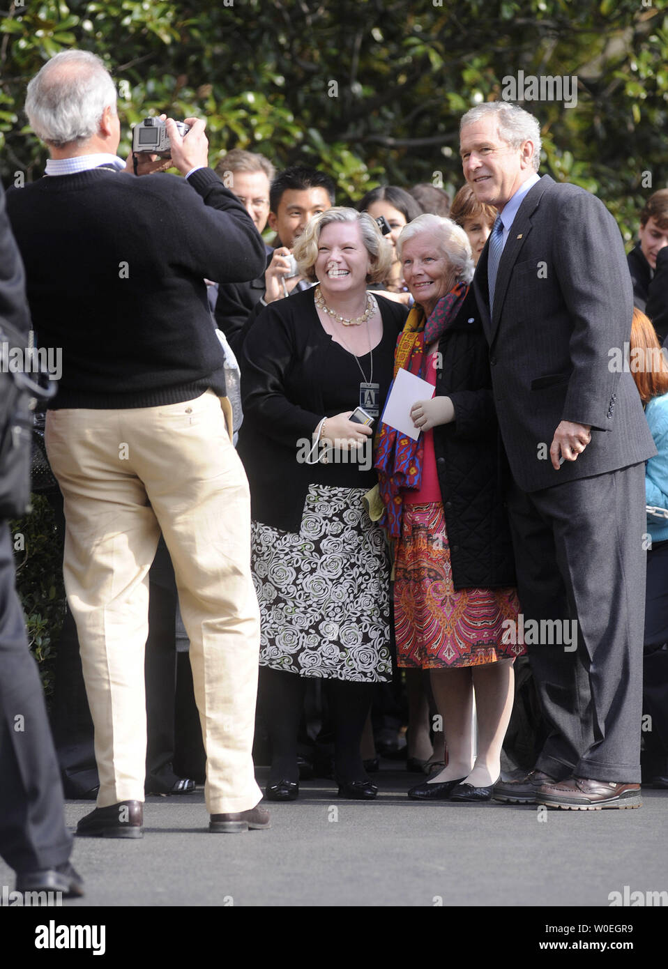 U.S President George W. Bush poses for a photograph as he greets ...