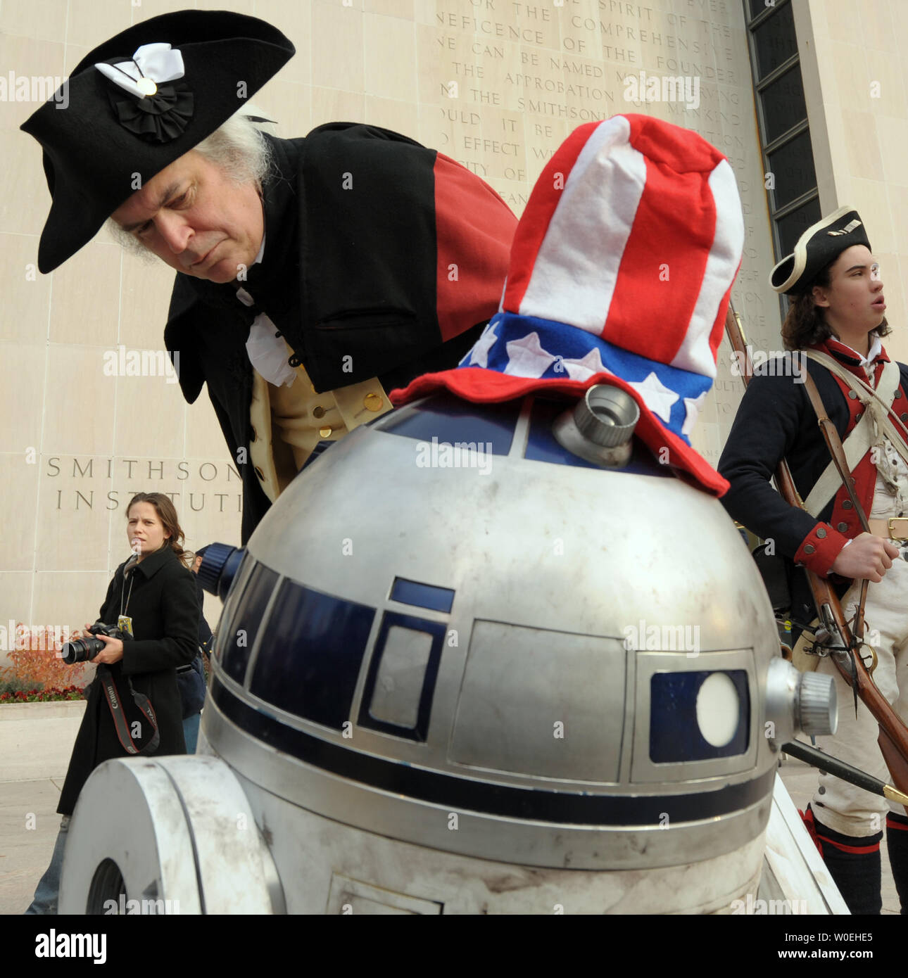 A man portraying General George Washington looks over a replica of Star ...