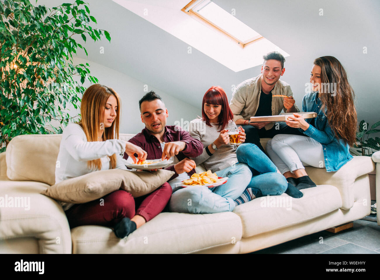 Group of happy friends bonding at home - Young adults having party and ...