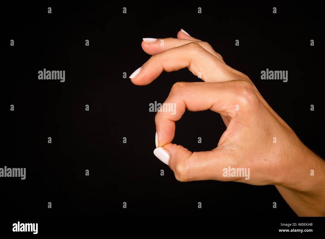 Ok gesture performed by a female hand Stock Photo - Alamy