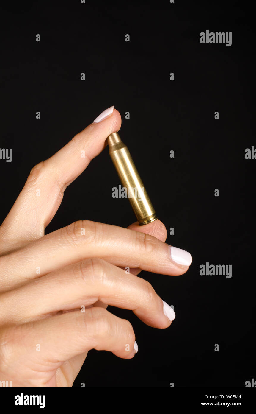 Female hand with bullet shells, a concept Stock Photo - Alamy