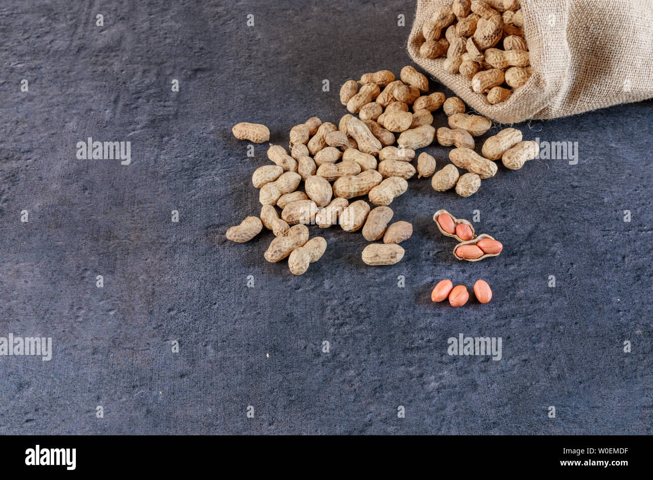 Peanuts poured out of a sack Stock Photo - Alamy