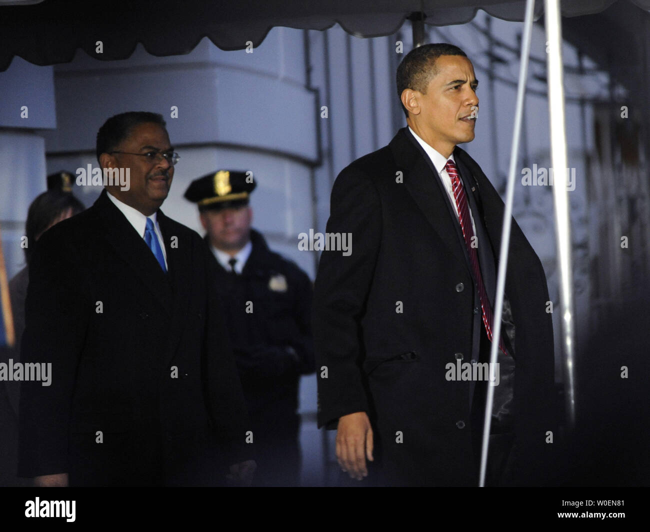 U S President Barack Obama R Walks Out Of The White House To Marine
