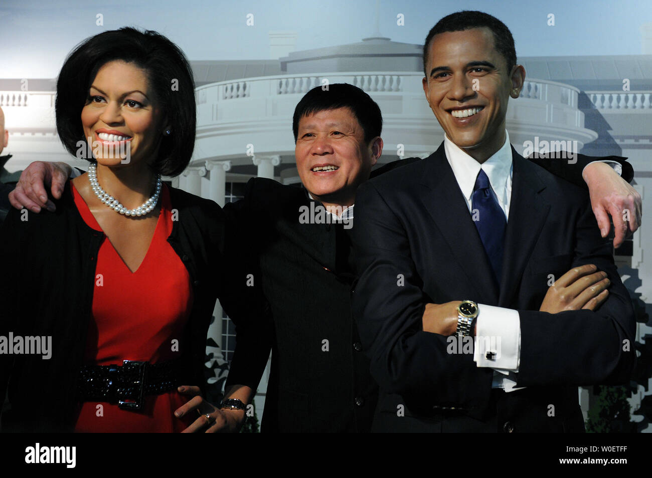 Tourists are photographed with wax figures of First Lady Michelle Obama ...