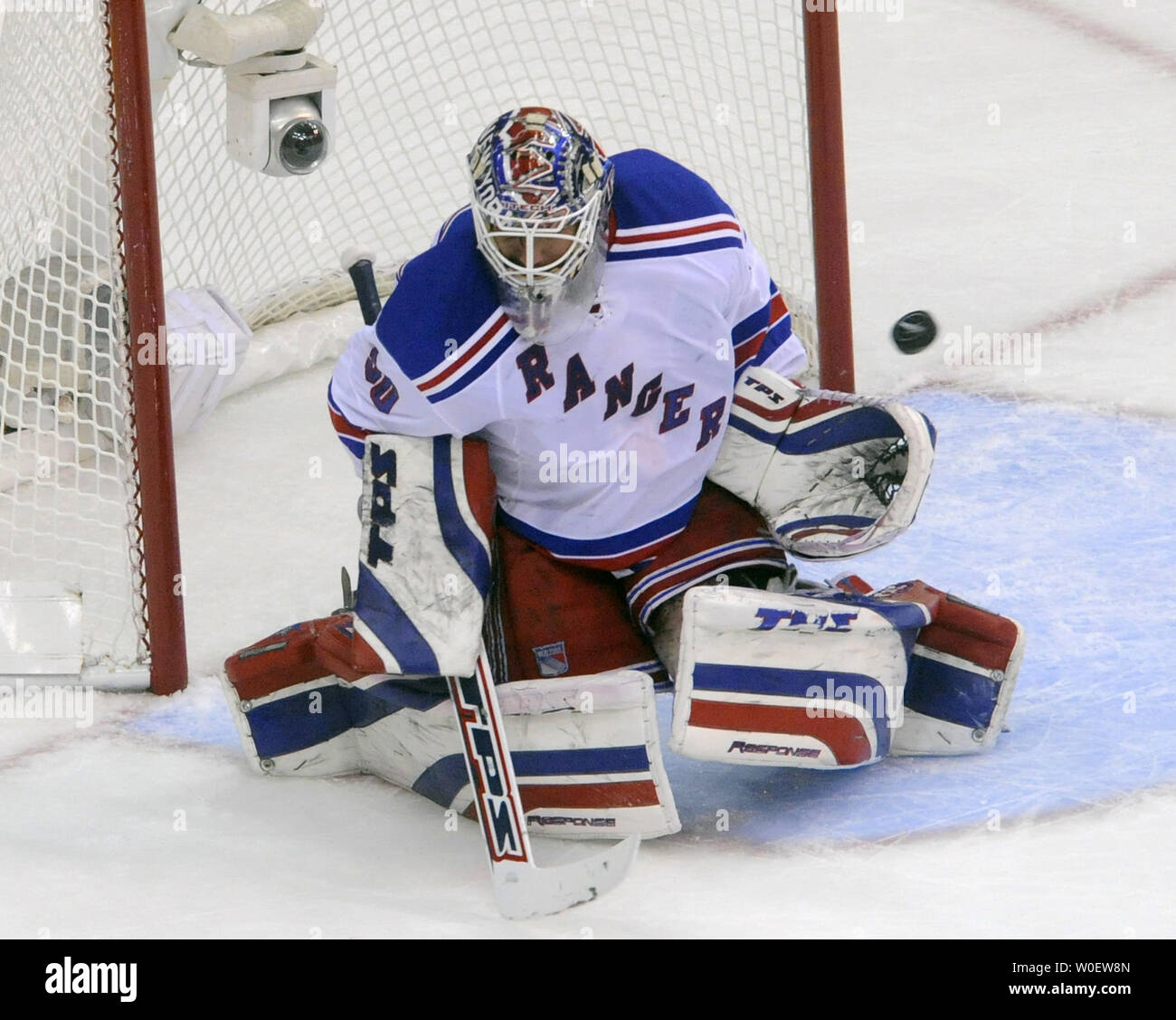 New York Rangers goaltender Henrik Lundqvist blocks a shot from the ...