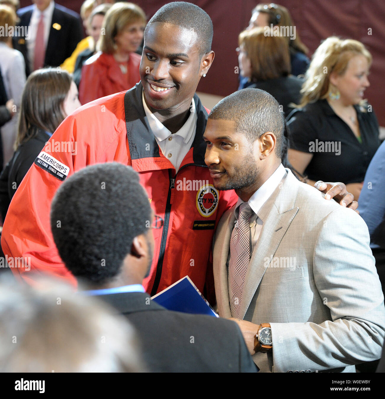 Hip-hop star Usher (R) poses with a guest before U.S. President Barack ...