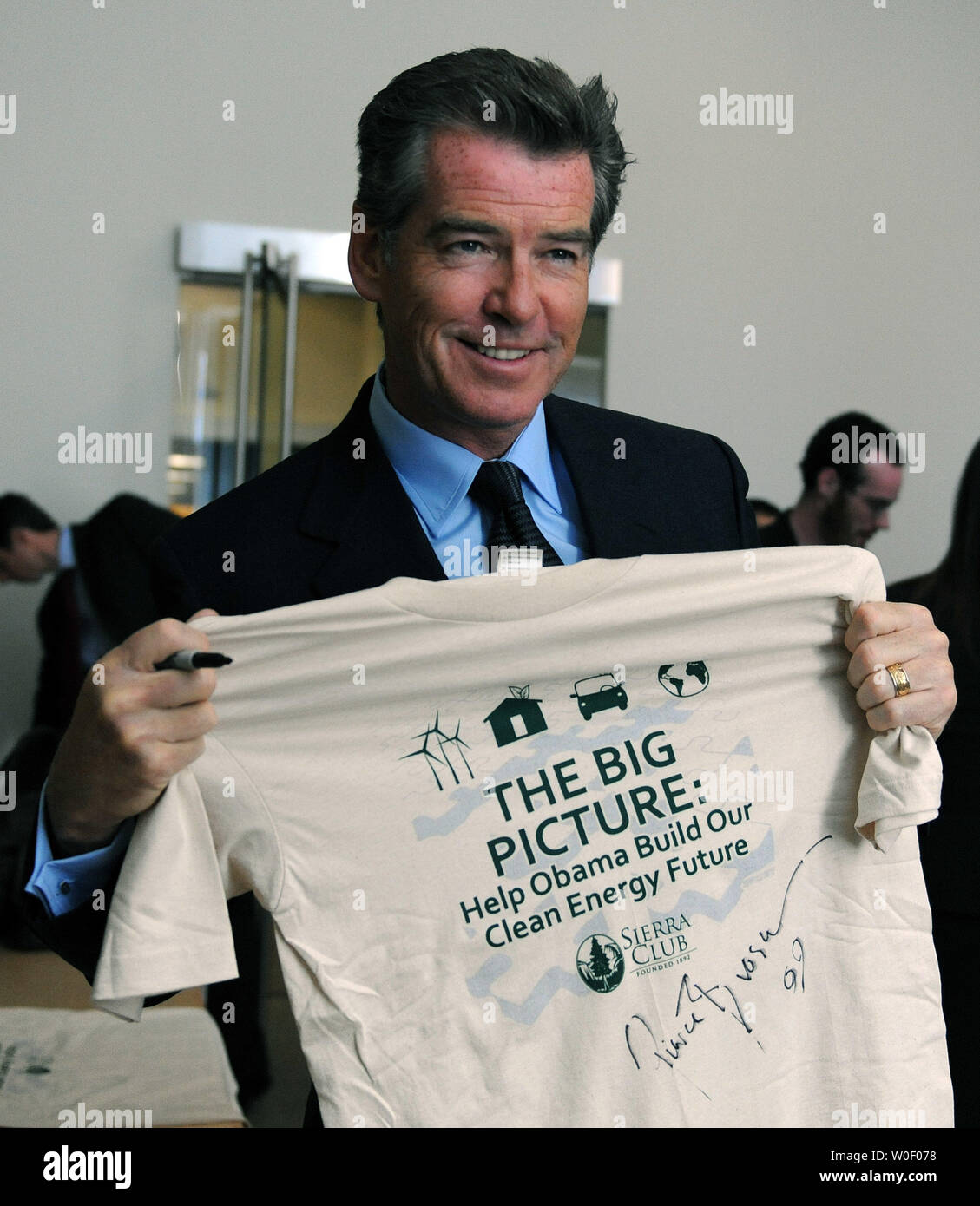 Actor Pierce Brosnan shows his autograph on a Sierra Club t-shirt after ...