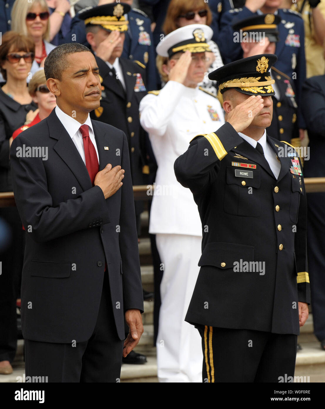 U.S. President Barack Obama holds his hand over his heart as Taps are ...