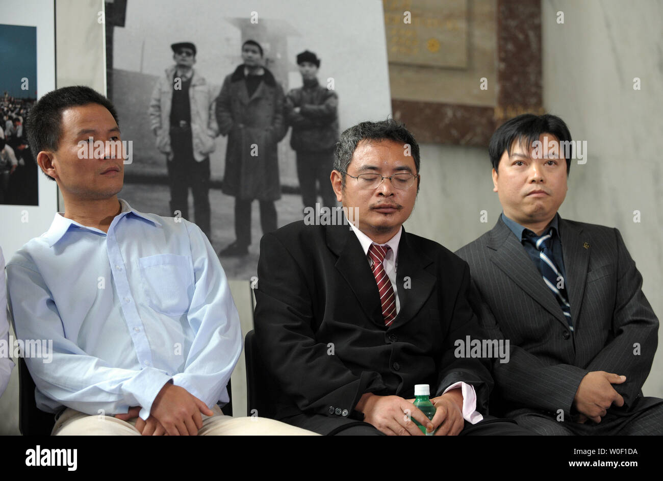 Yu Zhijian, Lu Decheng and Yu Dongyue (L to R) sit in front of their ...