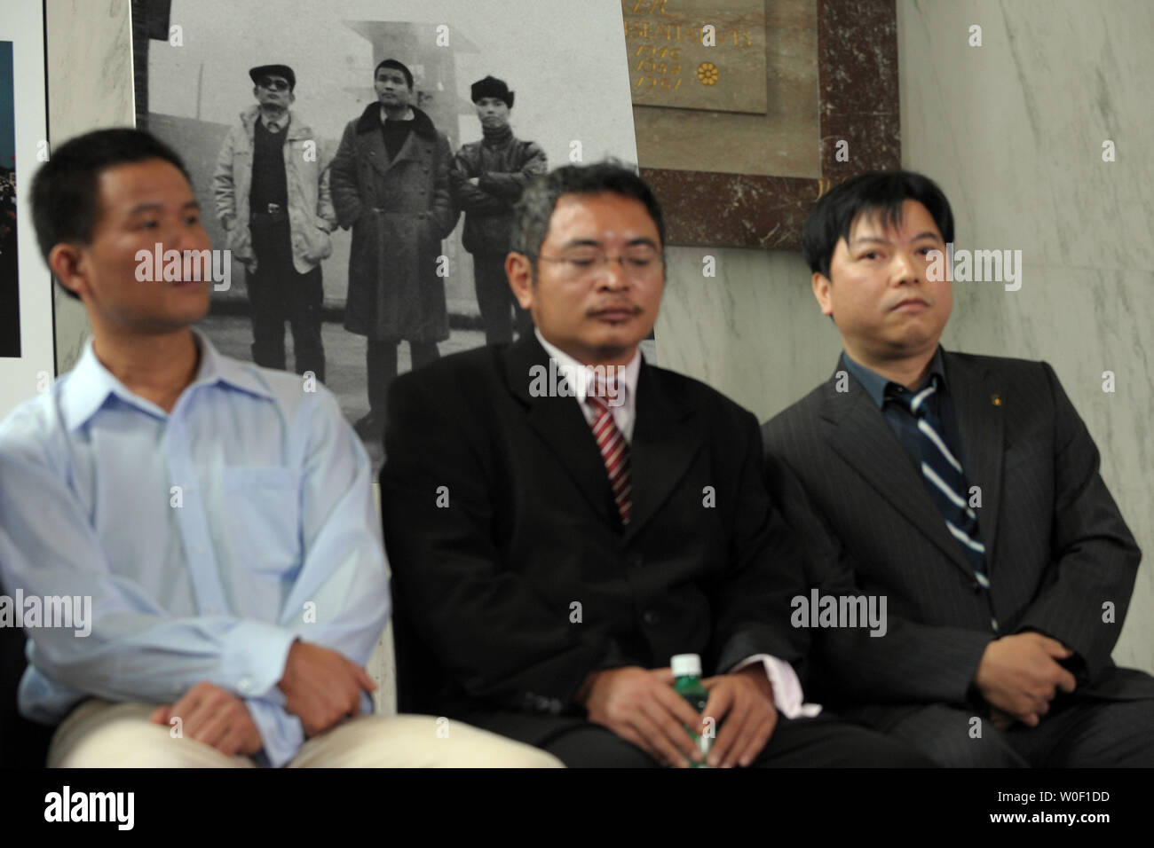 Yu Zhijian, Lu Decheng and Yu Dongyue (L to R) sit in front of their ...
