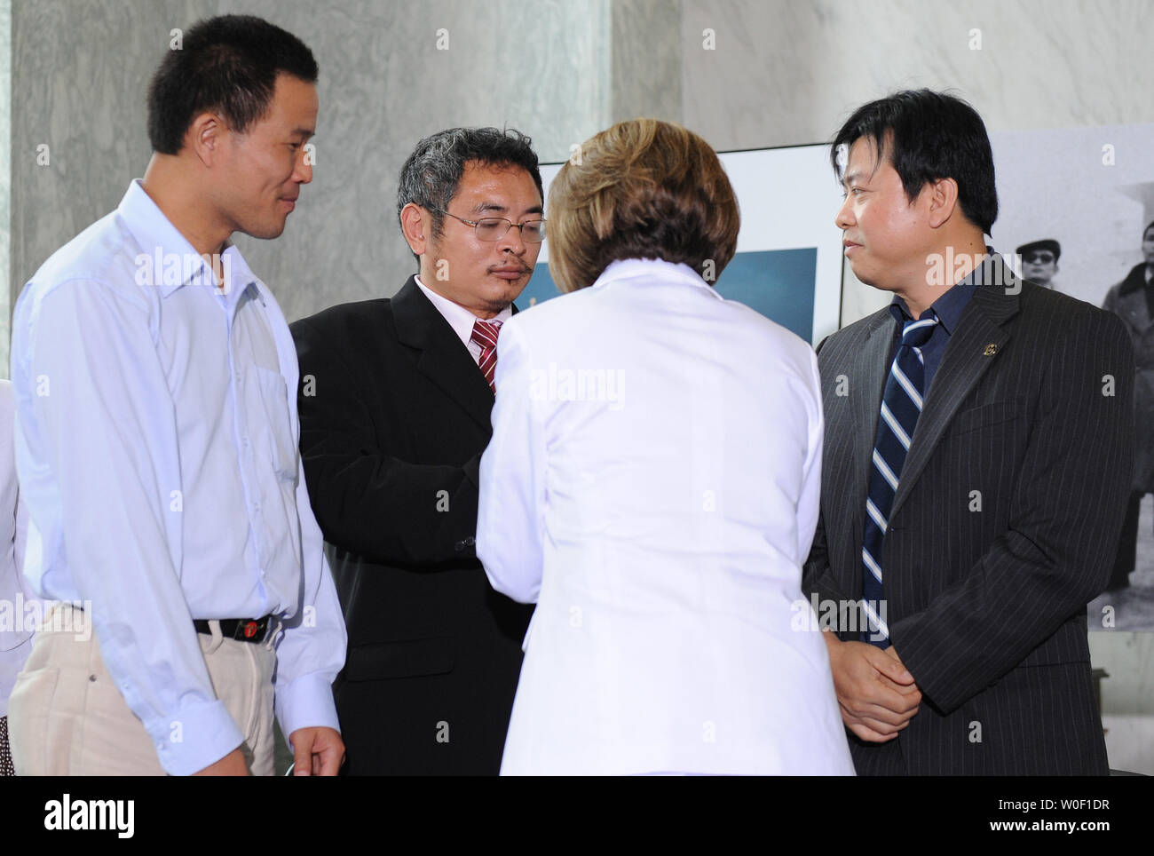 Yu Zhijian, Lu Decheng and Yu Dongyue (L to R) are greeted by Speaker ...