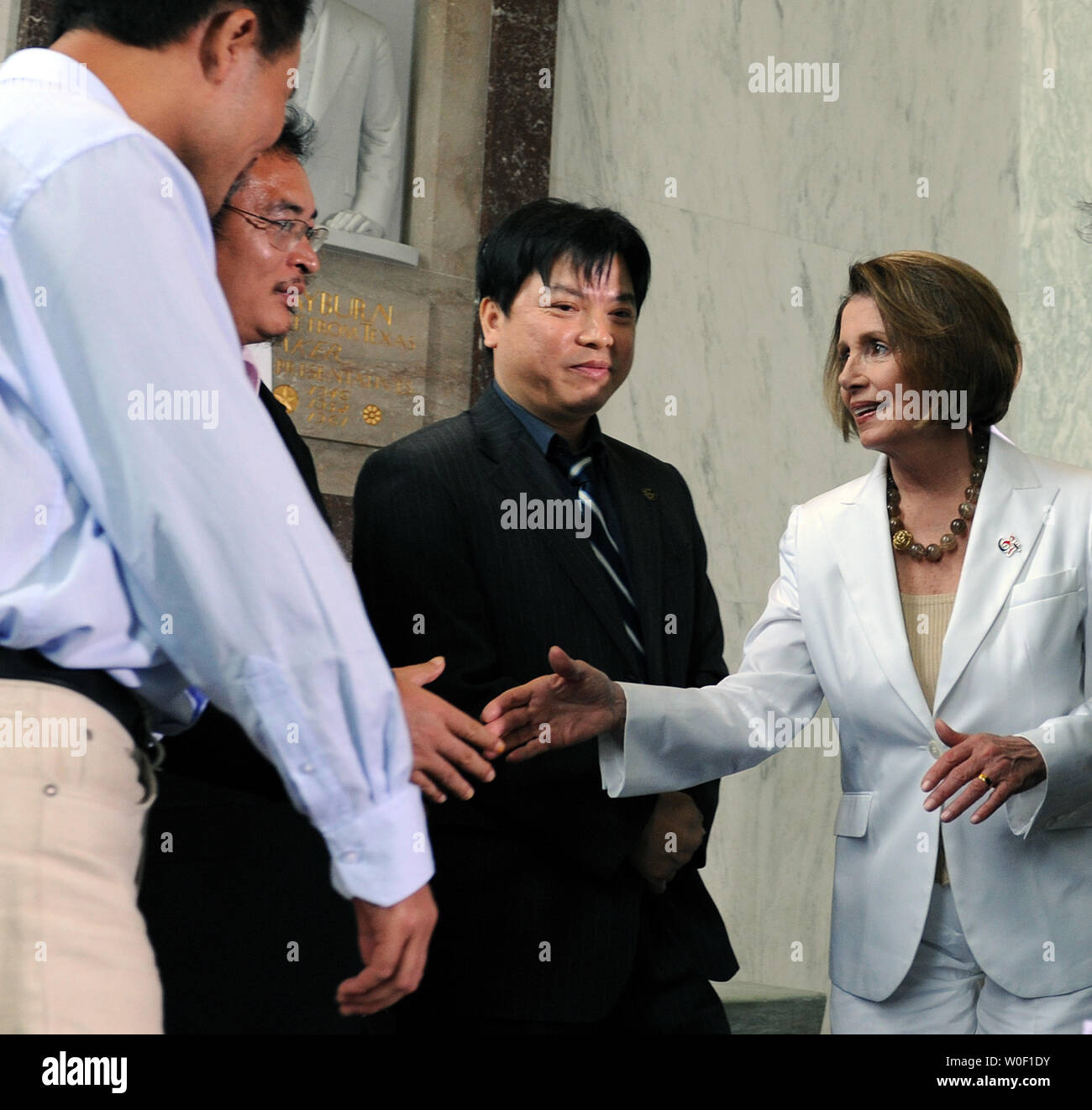 Yu Zhijian, Lu Decheng and Yu Dongyue (L to R) are greeted by Speaker ...