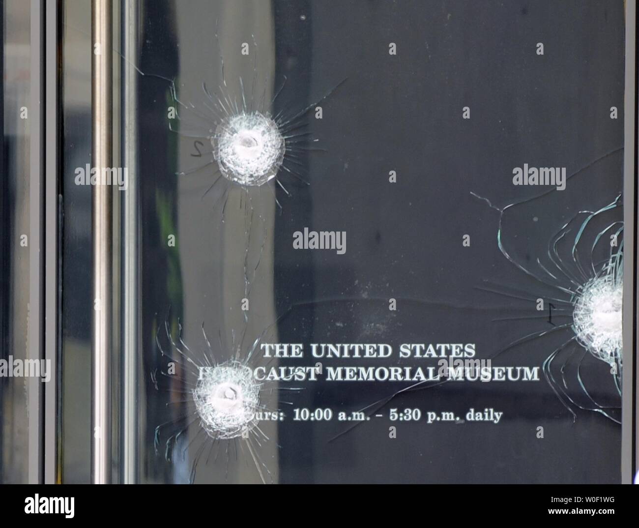 Glass doors damaged by gun shots are seen at the U.S. Holocaust ...