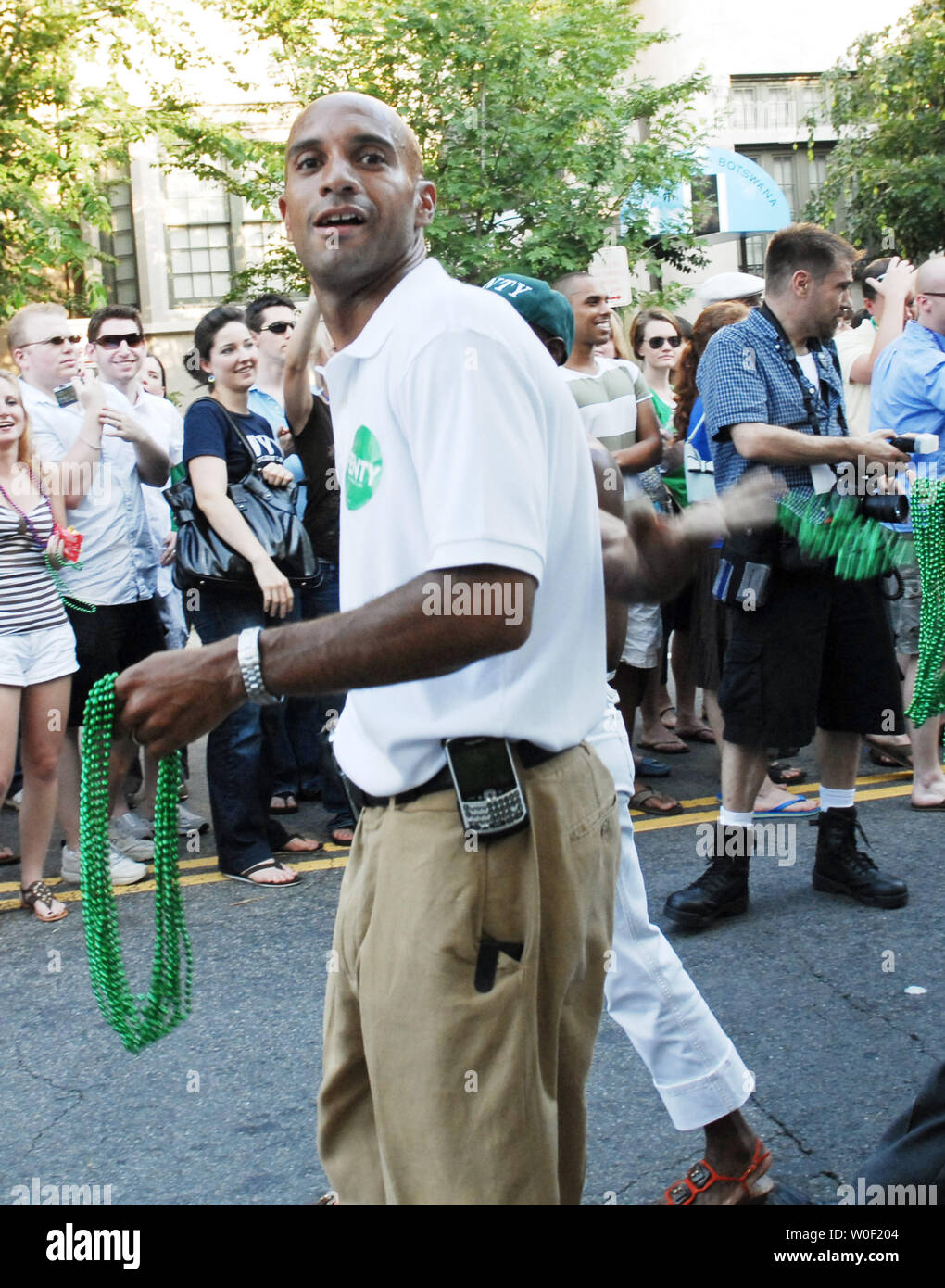 District of Columbia Mayor Adrian Fenty tosses beads to the crowd at ...