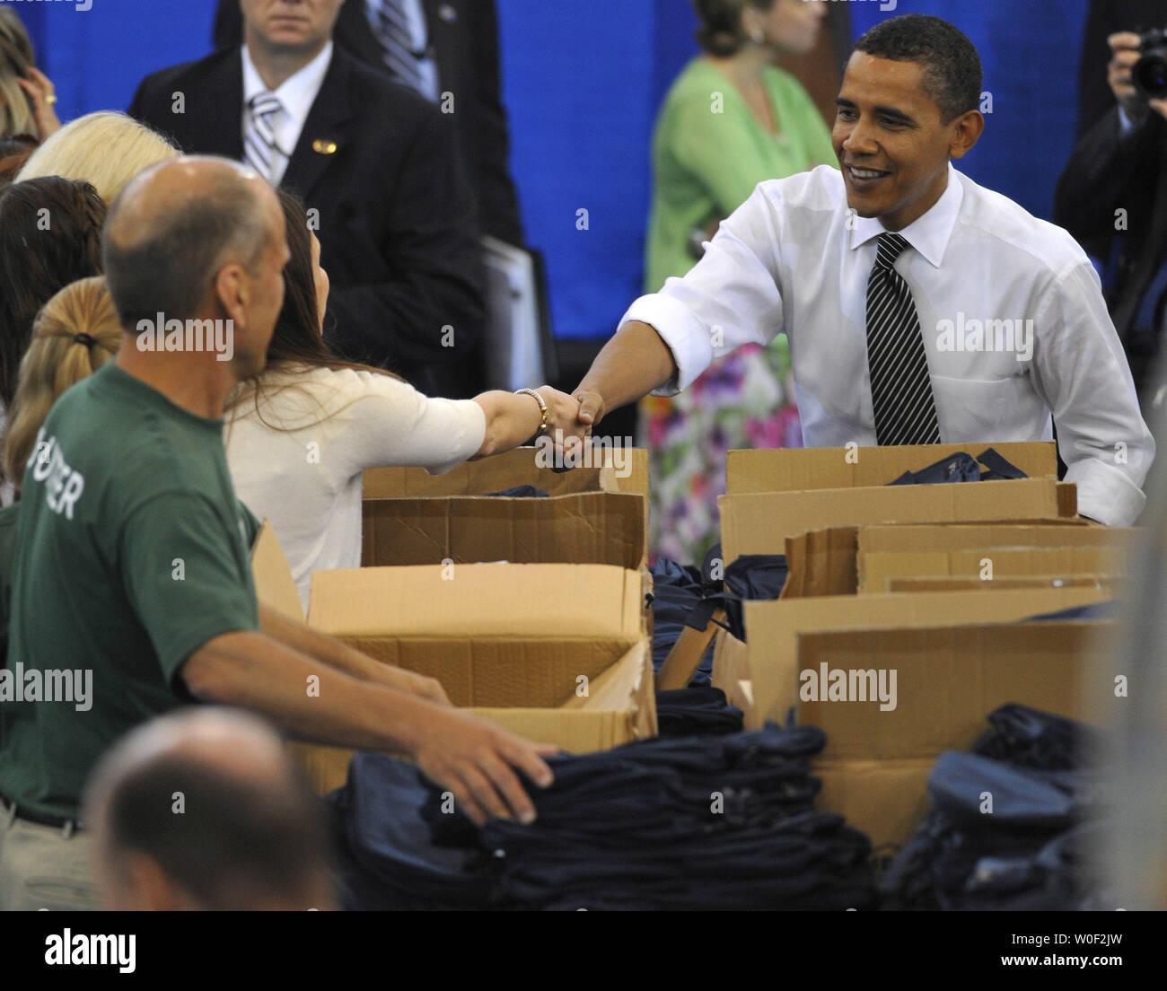 President Barack Obama greets a volunteer at a service event where he ...