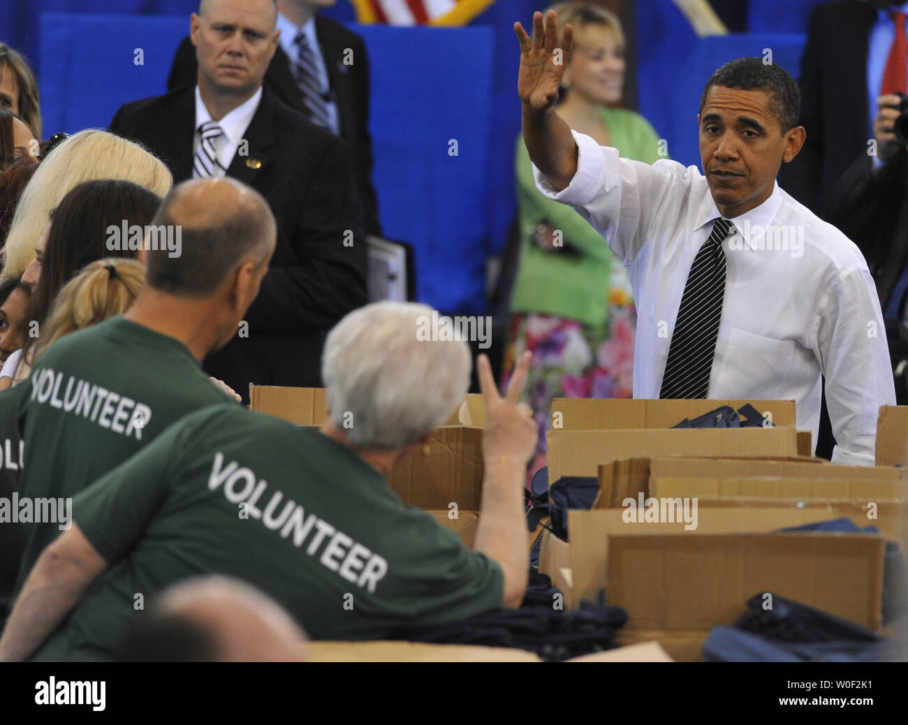 President Barack Obama greets a volunteer at a service event where he ...