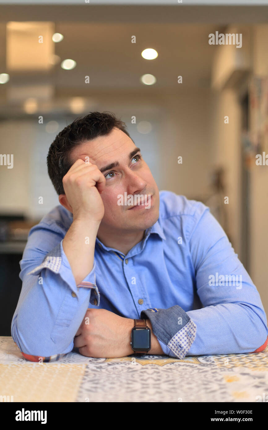 Man sitting on table Stock Photo - Alamy